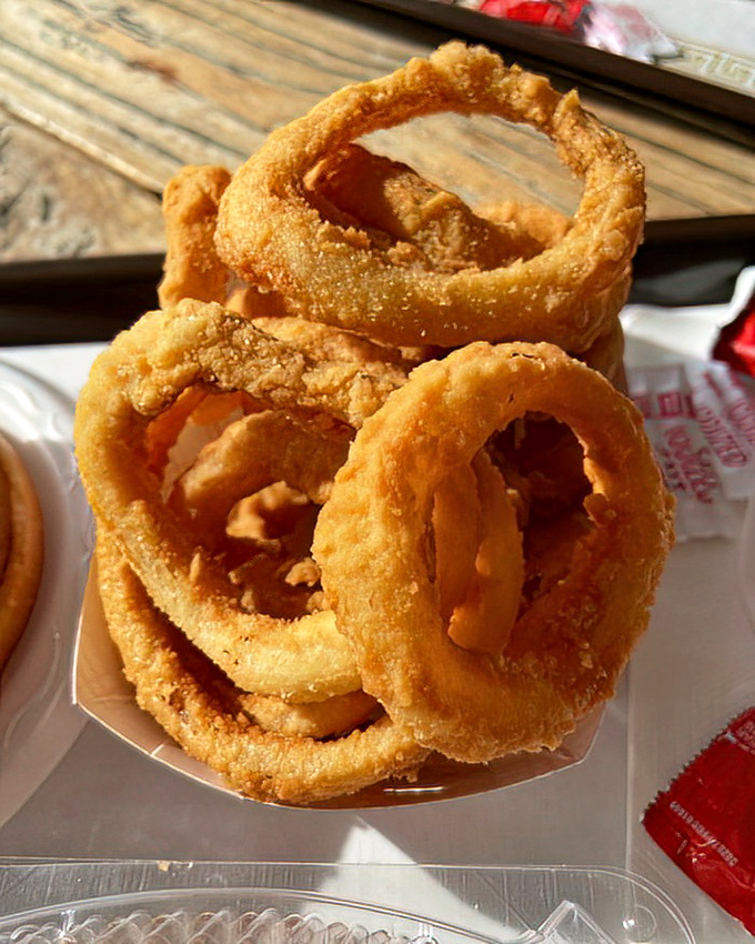 Onion rings stacked like golden halos, with a crunch that announces itself three tables away.