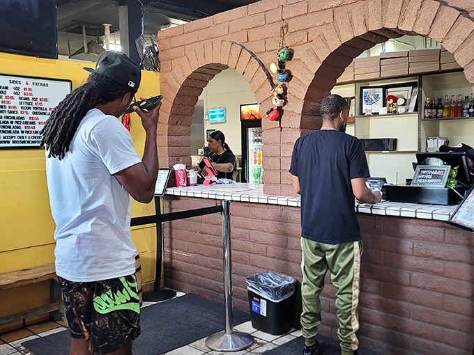 The moment of truth: placing your order at the counter where dreams of green chili greatness begin their journey to reality.