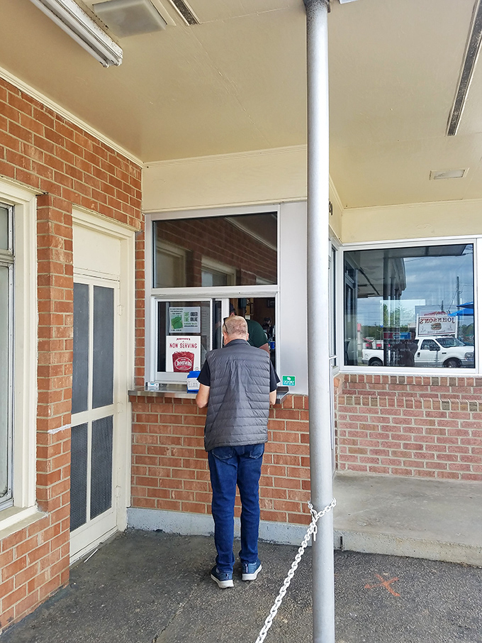 The ordering window: where hopes are high, patience is rewarded, and burger dreams come true for those who arrive before the "sold out" sign appears.