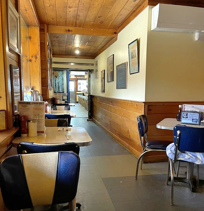 The wooden paneling and simple tables create a no-nonsense dining area where the food, not the decor, rightfully takes center stage.