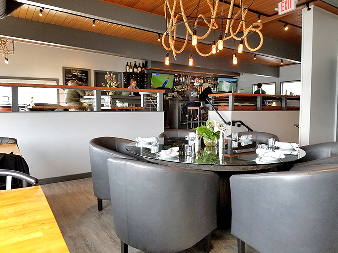 Industrial chic meets waterfront warmth in a space designed for lingering over exceptional meals.