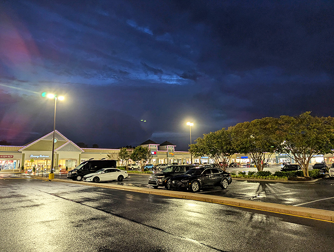 Even at night, Tanger Outlets glows with shopping possibility. The parking lot tells the truth: bargain hunters never rest.