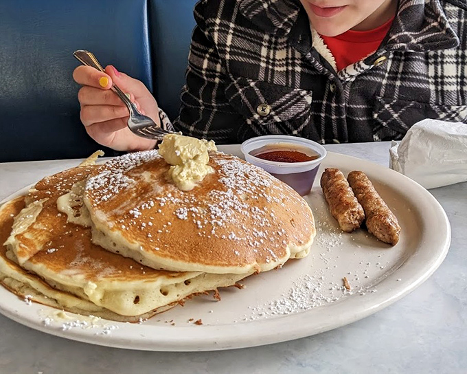 Pancakes so fluffy they're practically hovering above the plate. That melting butter pat is just showing off.