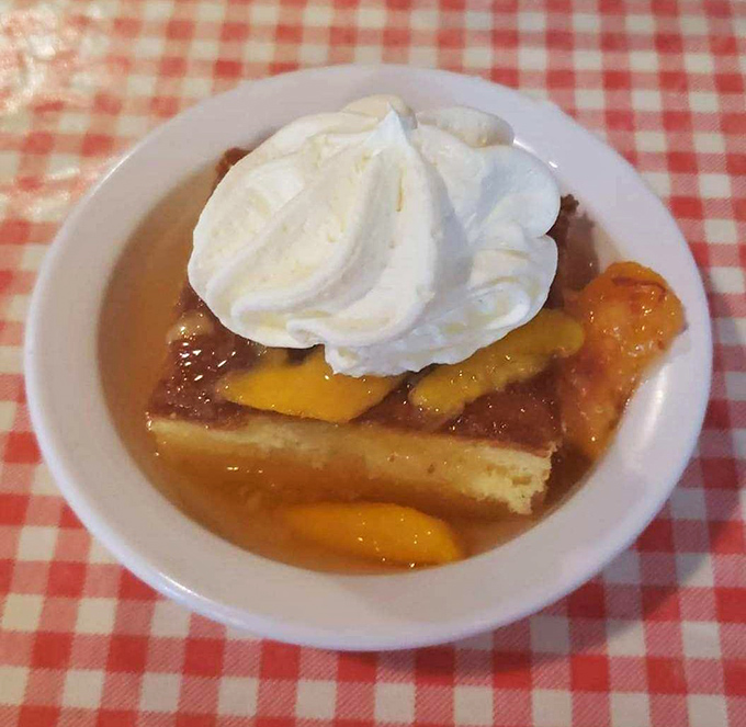 Peach cobbler swimming in its own sweet juices, topped with a cloud of whipped cream&mdash;dessert masquerading as breakfast.
