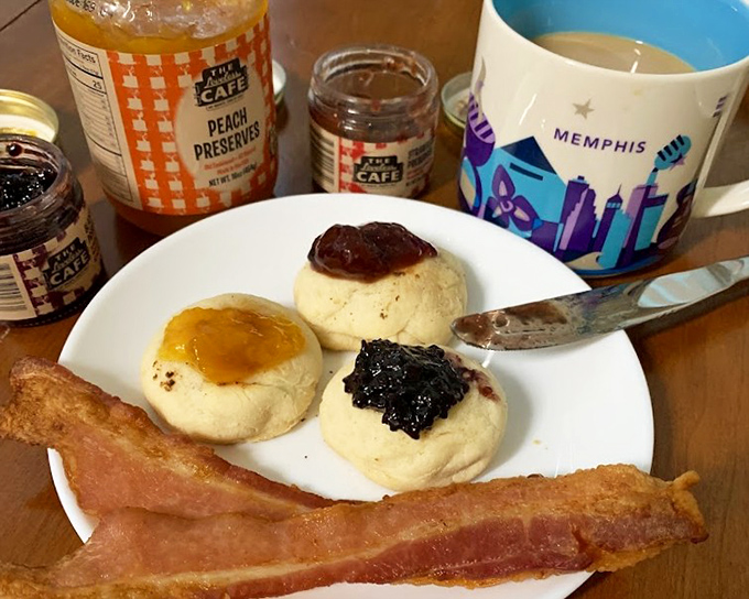 Biscuits so light they might float away if not anchored by preserves. Three different jams and country ham &ndash; breakfast paradise on a simple white plate.