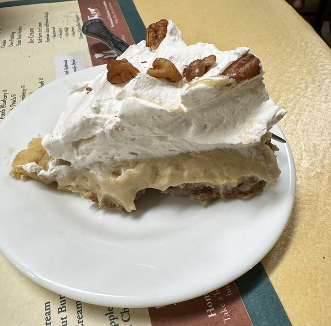 This slice of heaven isn't just dessert—it's an engineering marvel of cream, meringue, and nuts that makes you question why you ever waste calories on lesser sweets.