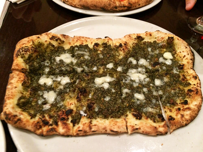 The pesto pizza looks like a green dream that would make other pizzas jealous. Herbaceous, bold, and unapologetically Italian.