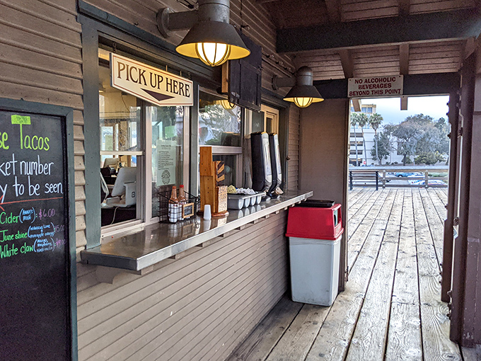 The "Pick Up Here" window: where dreams come true and patience is rewarded with paper-wrapped treasures.