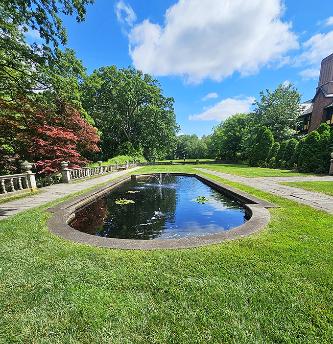 This reflecting pool surrounded by manicured lawns and Japanese maples proves that water features don't have to involve plastic flamingos to make a statement.