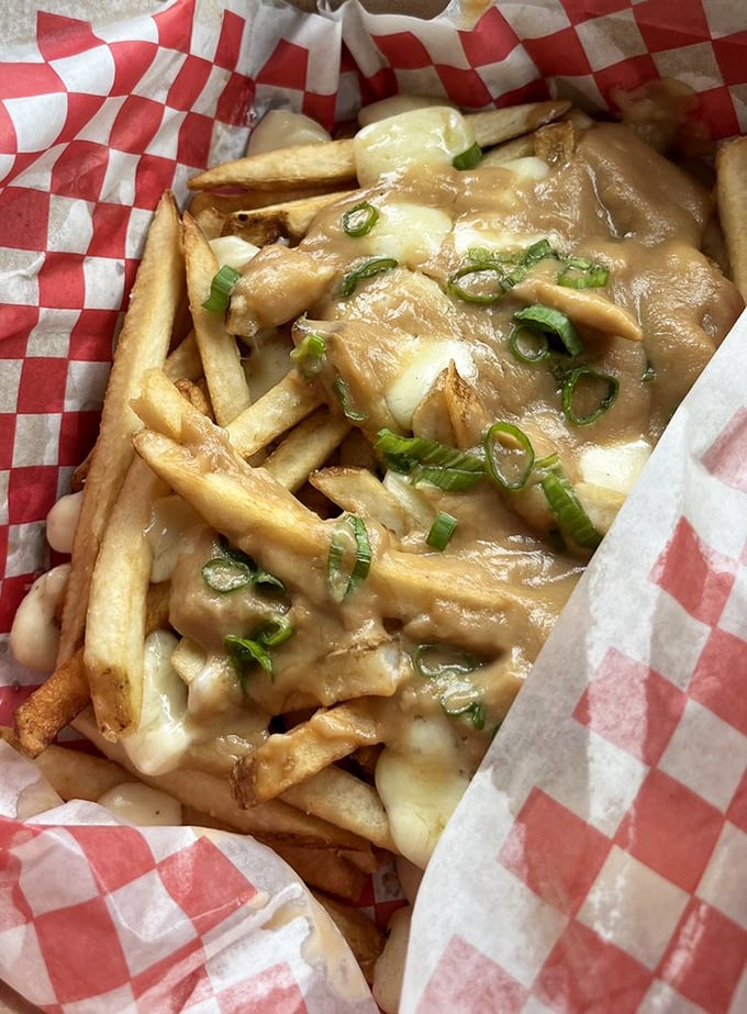 Gravy-smothered fries with melty cheese and green onions. Like a warm hug from a Canadian friend who really gets you.