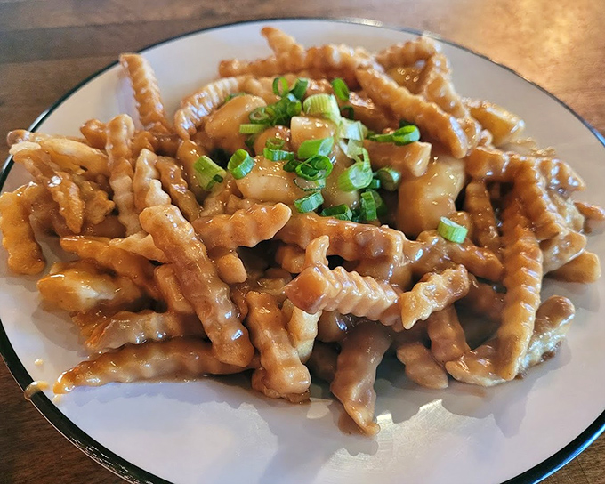 Poutine that transforms humble fries into a gravy-soaked masterpiece worthy of its own food network special.