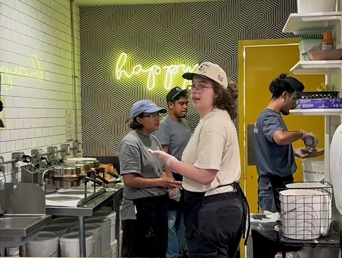 Behind-the-scenes action shows dedicated staff crafting frozen masterpieces with genuine care and obvious professional pride.