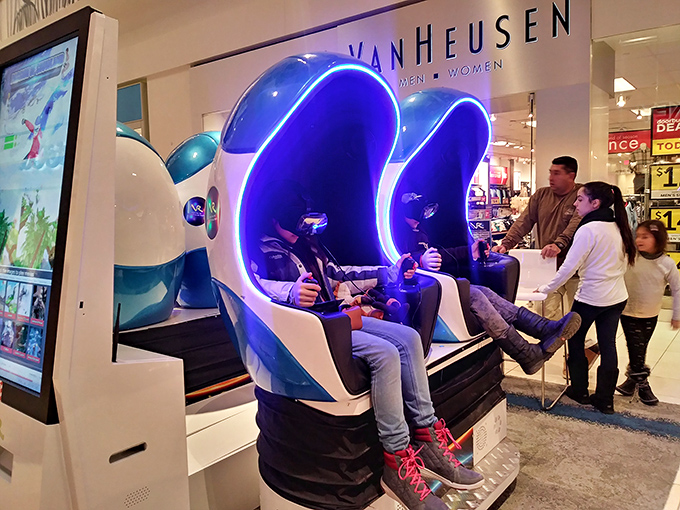 A rest area where husbands contemplate their life choices while holding shopping bags.