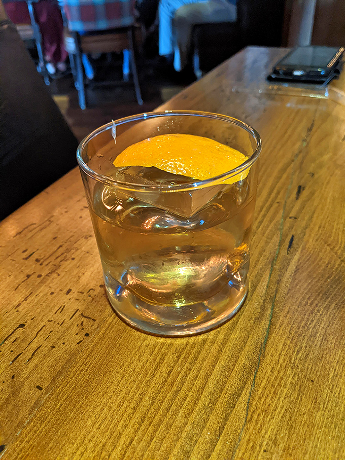 An Old Fashioned with proper ice and orange peel—proof that classics never go out of style for good reason.