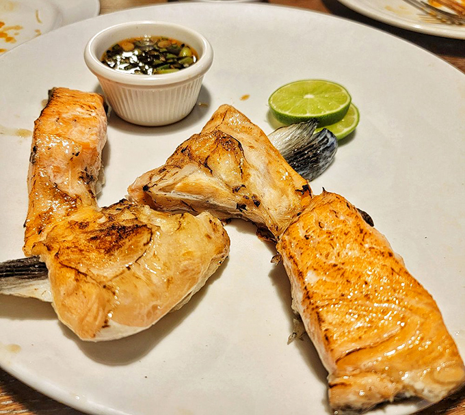 Salmon cheeks &ndash; the hidden treasure that seafood insiders order. Perfectly grilled with a squeeze of lime for brightness.