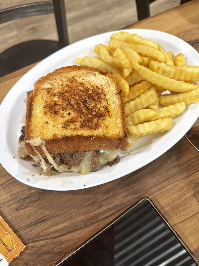 That patty melt on grilled bread with waffle fries is what happens when lunch decides to get serious about satisfaction.
