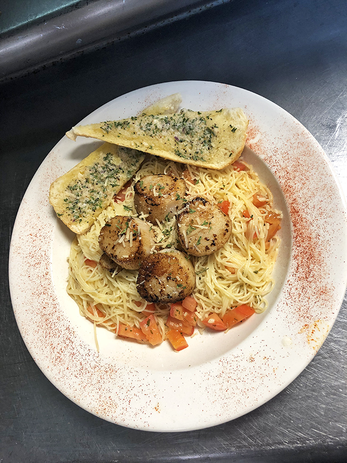 Scallops seared to golden perfection atop angel hair pasta with diced tomatoes and garlic bread on standby. Seafood this good in Ohio? Believe it.