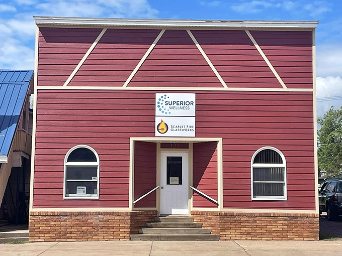 Superior Wellness occupies a classic red storefront that adds vibrant character to Washburn's architectural tapestry of preserved commercial buildings.