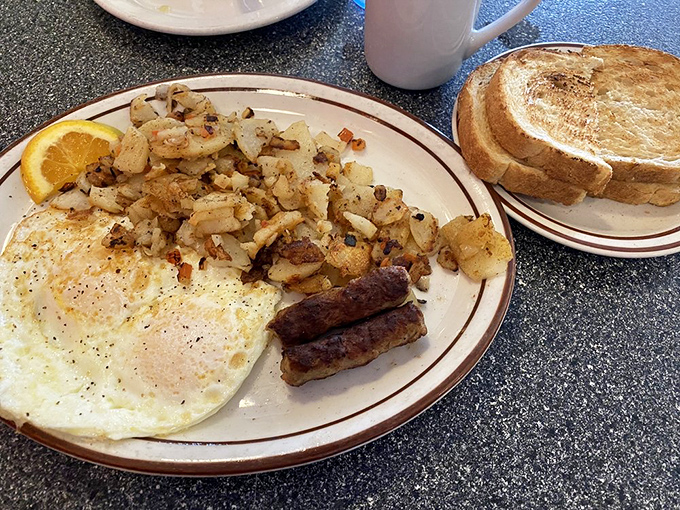 The classic American breakfast in its natural habitat &ndash; eggs, sausage, and home fries performing the morning ritual that's kept America running for generations.