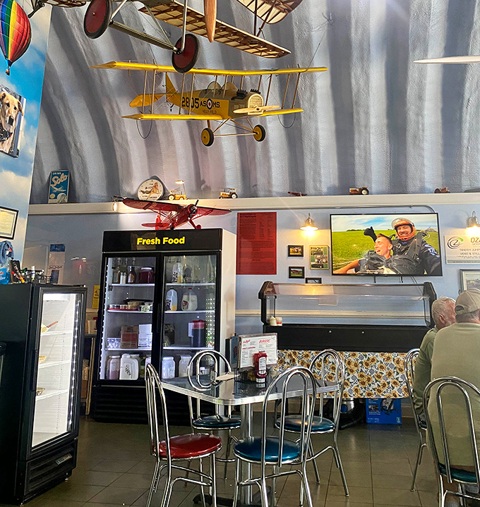 The kitchen command center where breakfast dreams take shape. Even the cooking area maintains the aviation theme with model planes watching over the grill.