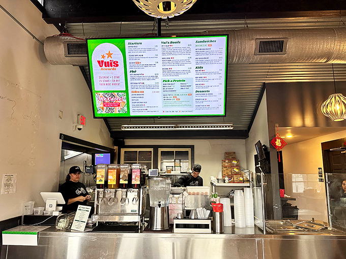 The heart of the operation: where friendly staff orchestrate your Vietnamese feast with digital menus glowing like beacons of culinary promise.