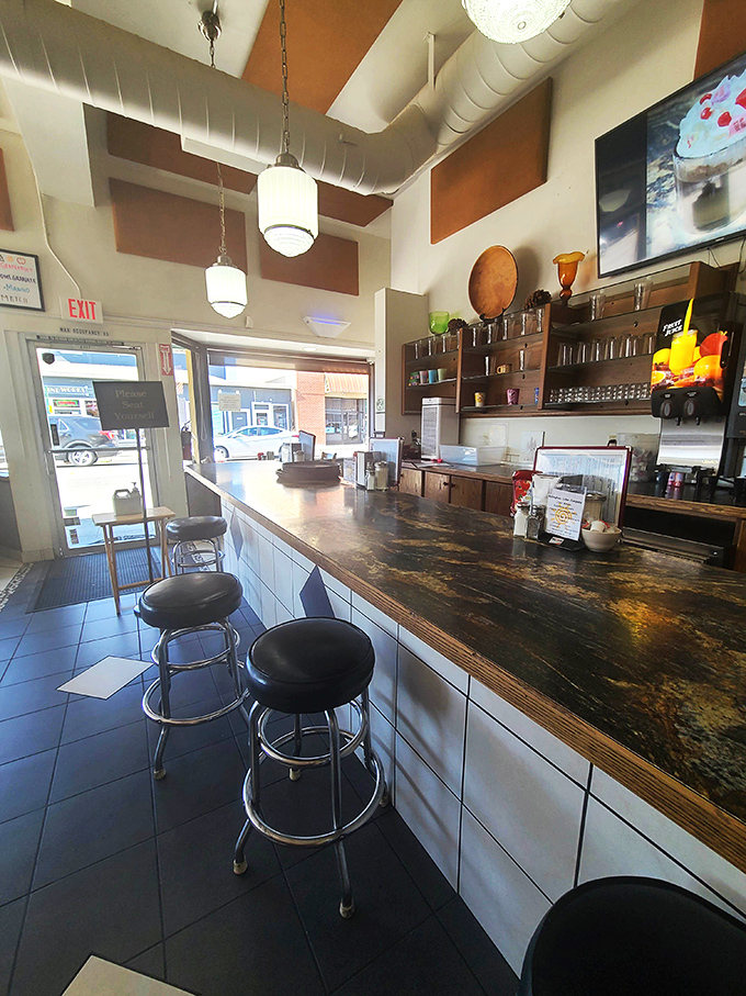 At the service counter, every stool is a front-row seat to the breakfast theater that unfolds daily.
