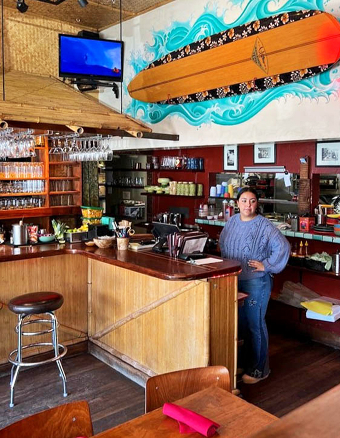 Behind every great tiki bar is a service counter where tropical magic happens—note the surfboard art riding a wave of turquoise.