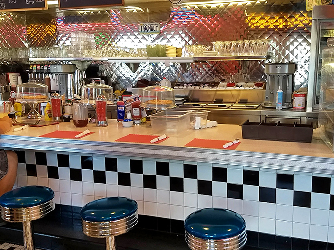 The counter where magic happens&mdash;blue stools awaiting the next lucky diners who'll perch here for front-row culinary theater.