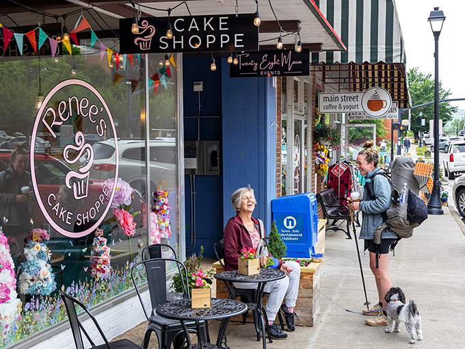 Outside Renee's Cake Shoppe, hikers and locals mingle in that perfect small-town tableau where calories from homemade pastries are justified by "mountain air metabolism."