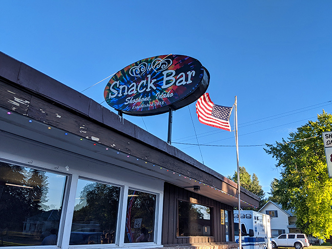 The Snack Bar's vintage sign glows against the Idaho sky, a beacon for hungry travelers that's been serving up Americana with a side of small-town hospitality.