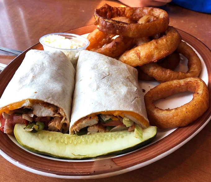 A wrap that actually stays wrapped, paired with onion rings that could double as golden halos. Fast food wishes it could be this good.