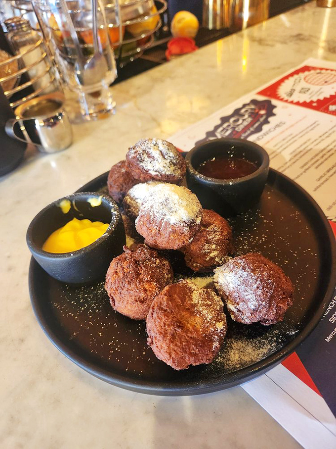 These "Space Balls" aren't from a Mel Brooks movie, but they're equally memorable&mdash;warm, sweet fritters dusted with powdered sugar and served with dipping sauces.