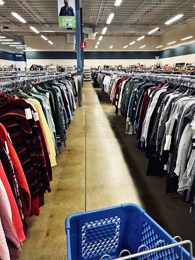 The clothing section stretches toward the horizon like a textile sea. Blue shopping baskets stand ready for your inevitable haul.