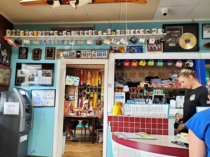 A collection of coffee mugs lines the wall above merchandise displays. The Coffee Cup doesn't just serve breakfast &ndash; it offers souvenirs of your flavor-filled adventure.