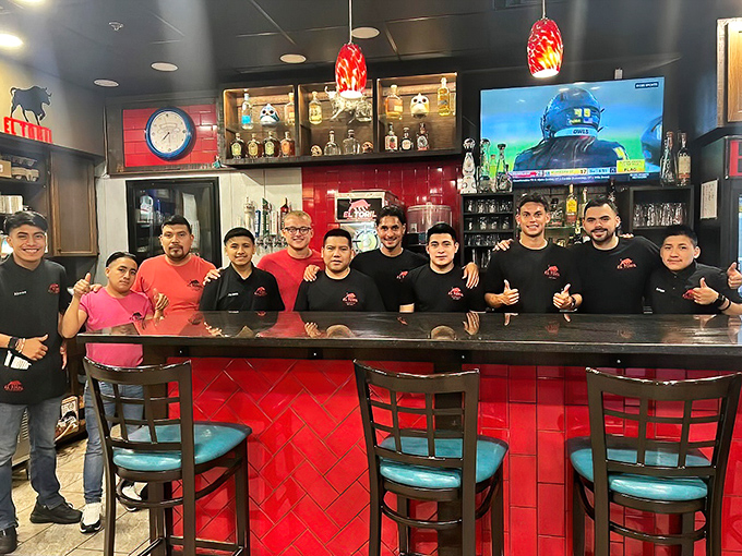 The bar's vibrant red tile backsplash mirrors the passion that goes into every drink. A spectrum of flavors awaits in those colorful bottles.