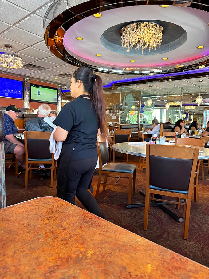 Under that spectacular chandelier, servers navigate the dining room with the precision of air traffic controllers and the warmth of old friends.