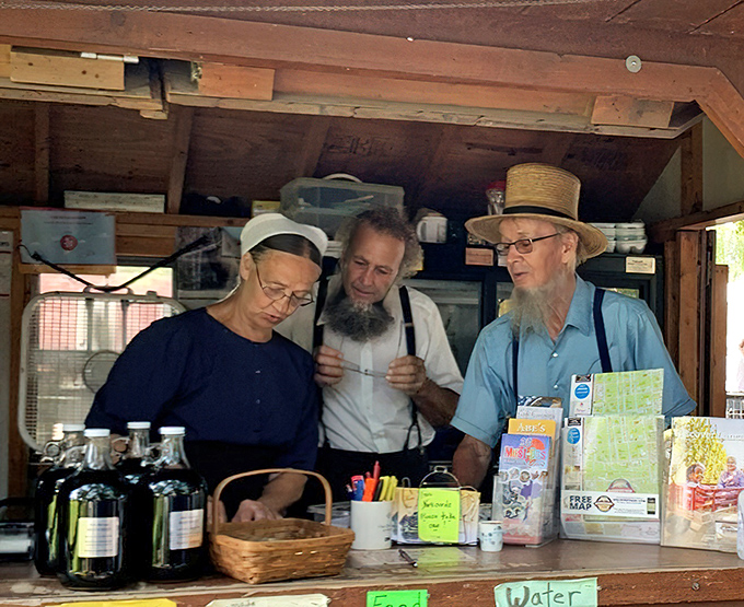 Amish staff members discuss the day's operations, their traditional attire a living connection to centuries of unchanged customs.