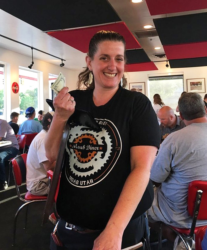 The servers here don't just bring food&mdash;they bring personality. That smile says, "Trust me, you're about to have the best meal of your vacation."