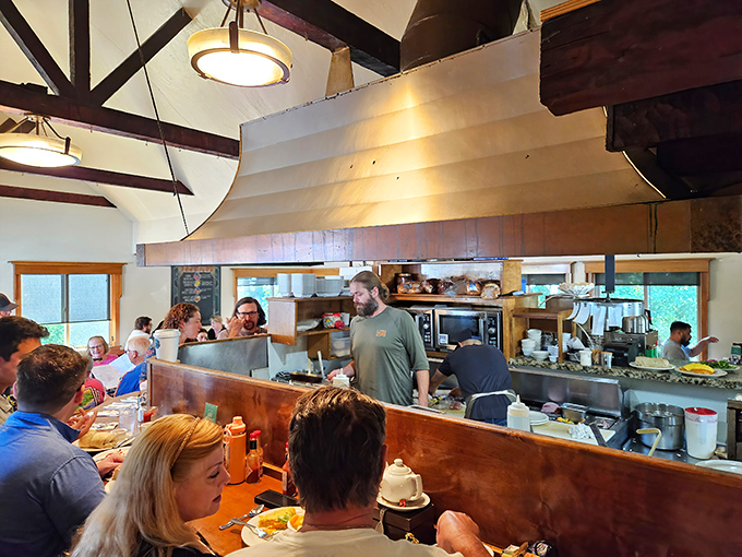 The open kitchen concept lets you witness breakfast alchemy in action. These culinary wizards move with the choreographed precision of a well-rehearsed dance troupe.