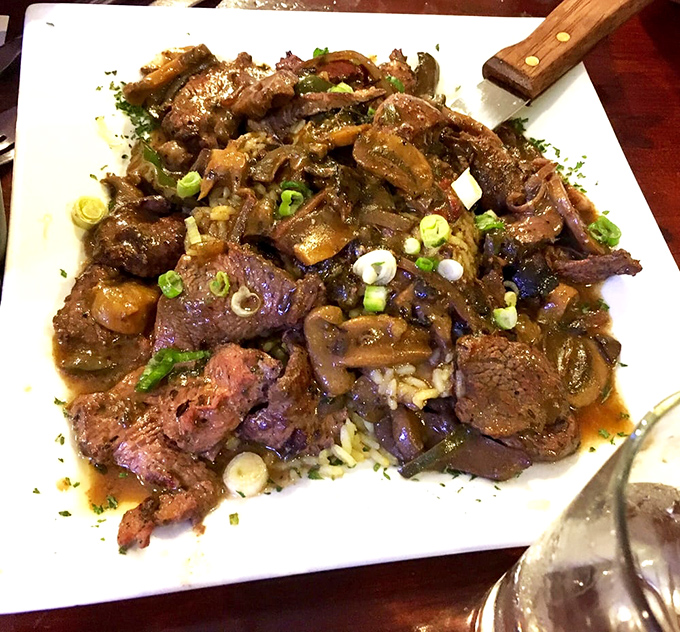 These steak tips aren't just cooked; they've been transformed into flavor bombs, each bite a carnivorous celebration atop a bed of rice.