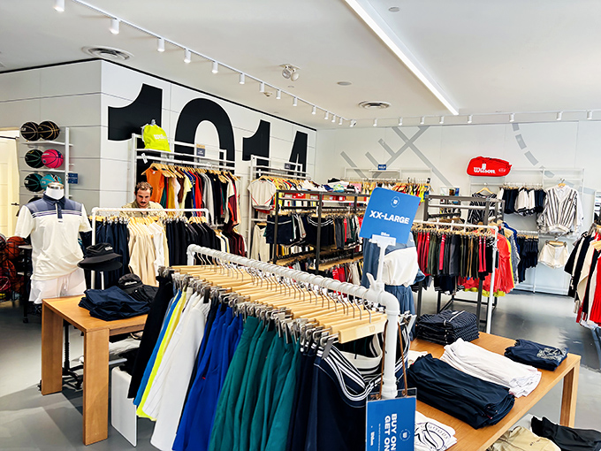 Caught between racks of athletic gear, this shopper looks like someone on a mission&mdash;proof that the perfect find is always worth the search.