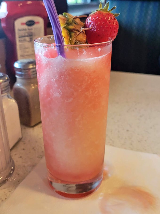 A strawberry-garnished drink that looks like summer decided to visit your table, regardless of the season outside.