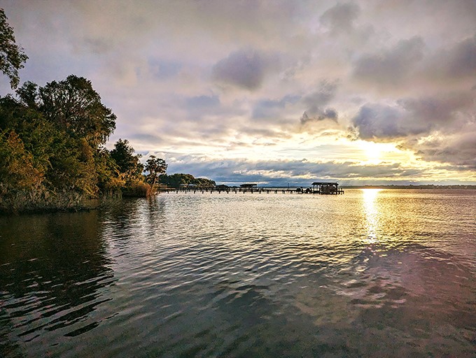 Sunset over the St. Johns River paints the water gold, creating the kind of view that makes smartphone cameras feel woefully inadequate.