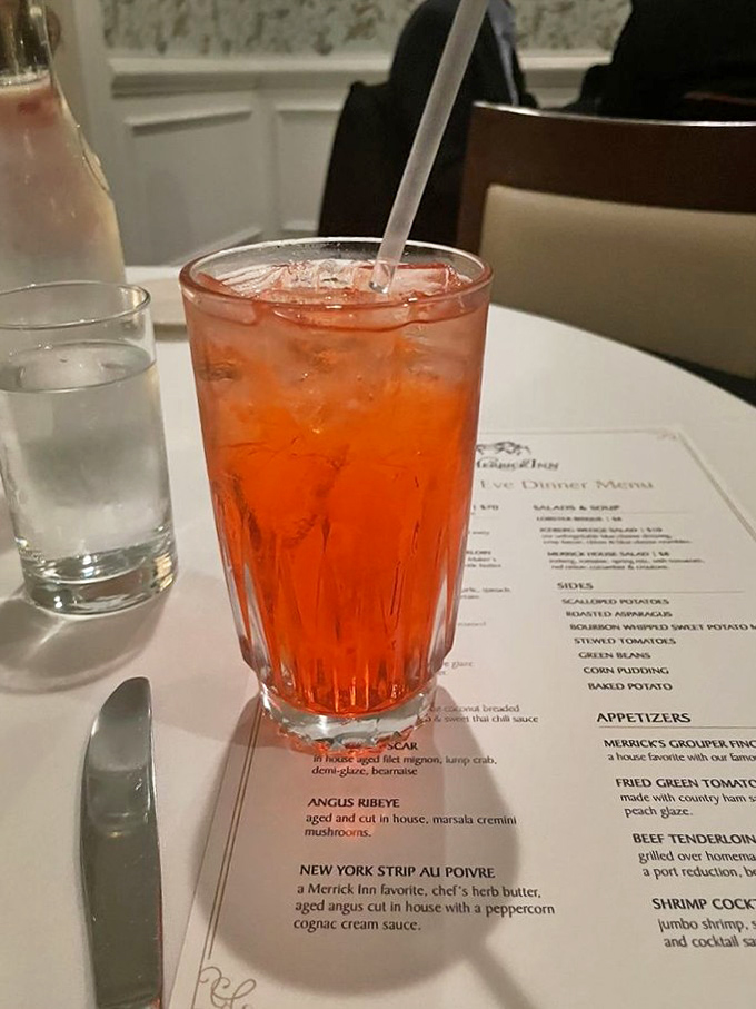 Blue velvet drapes and floral wallpaper create an ambiance that's fancy without being fussy, elegant without requiring formal wear nervously.