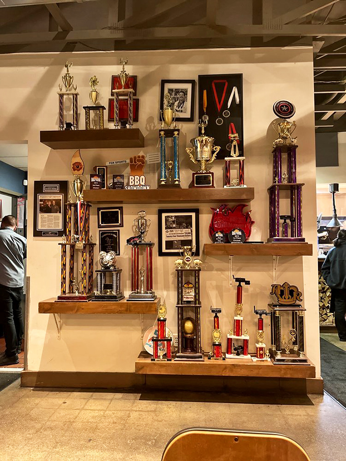 The trophy wall tells the story without words &ndash; these folks competed, conquered, and now share their championship barbecue with lucky diners.