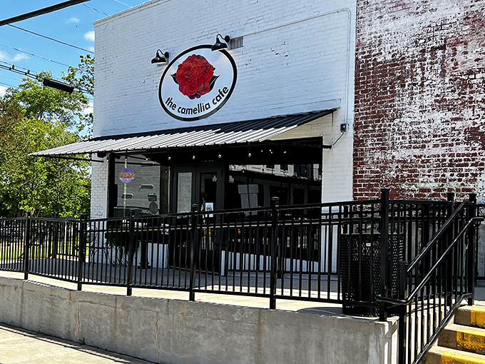 The Camellia Cafe's inviting facade promises comfort food with a side of local conversation. Southern hospitality blooms year-round behind these doors.
