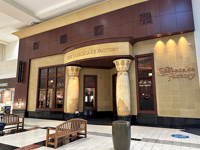The Cheesecake Factory's Egyptian-inspired entrance stands as a monument to excess, both architectural and caloric. Diet plans come here to die.