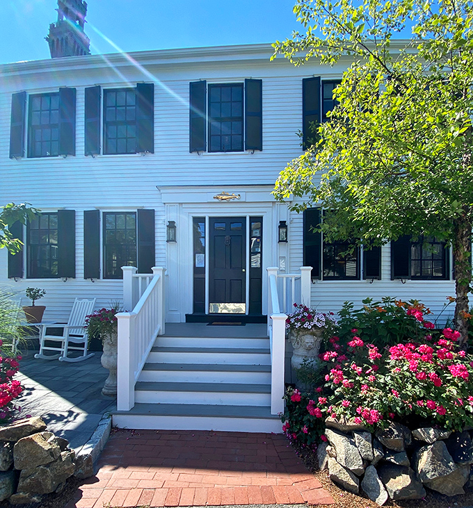 Classic Cape Cod architecture with flowers blooming everywhere&mdash;this is what charming coastal living actually looks like.