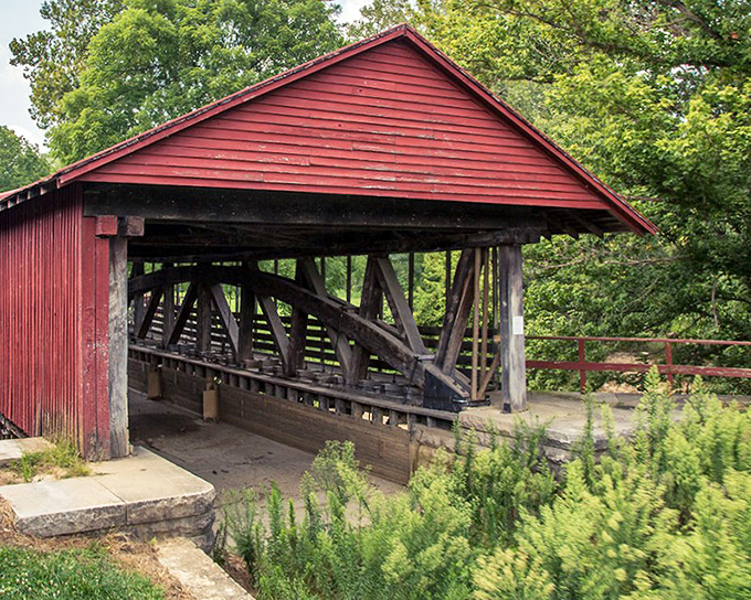 The Duck Creek Aqueduct wears its weathered red coat with pride. This wooden covered bridge for boats proves that practical engineering can also be picturesque.