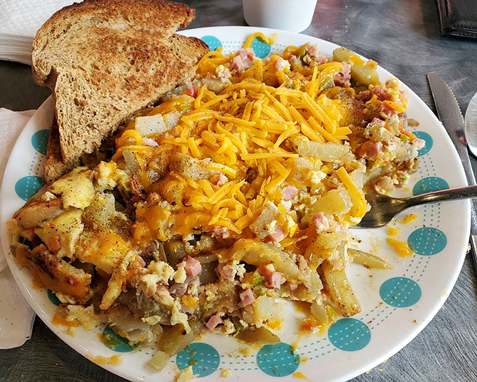 A beautiful mess indeed&mdash;potatoes, eggs, and cheese performing a delicious dance together while that cinnamon raisin toast waits patiently for its moment.